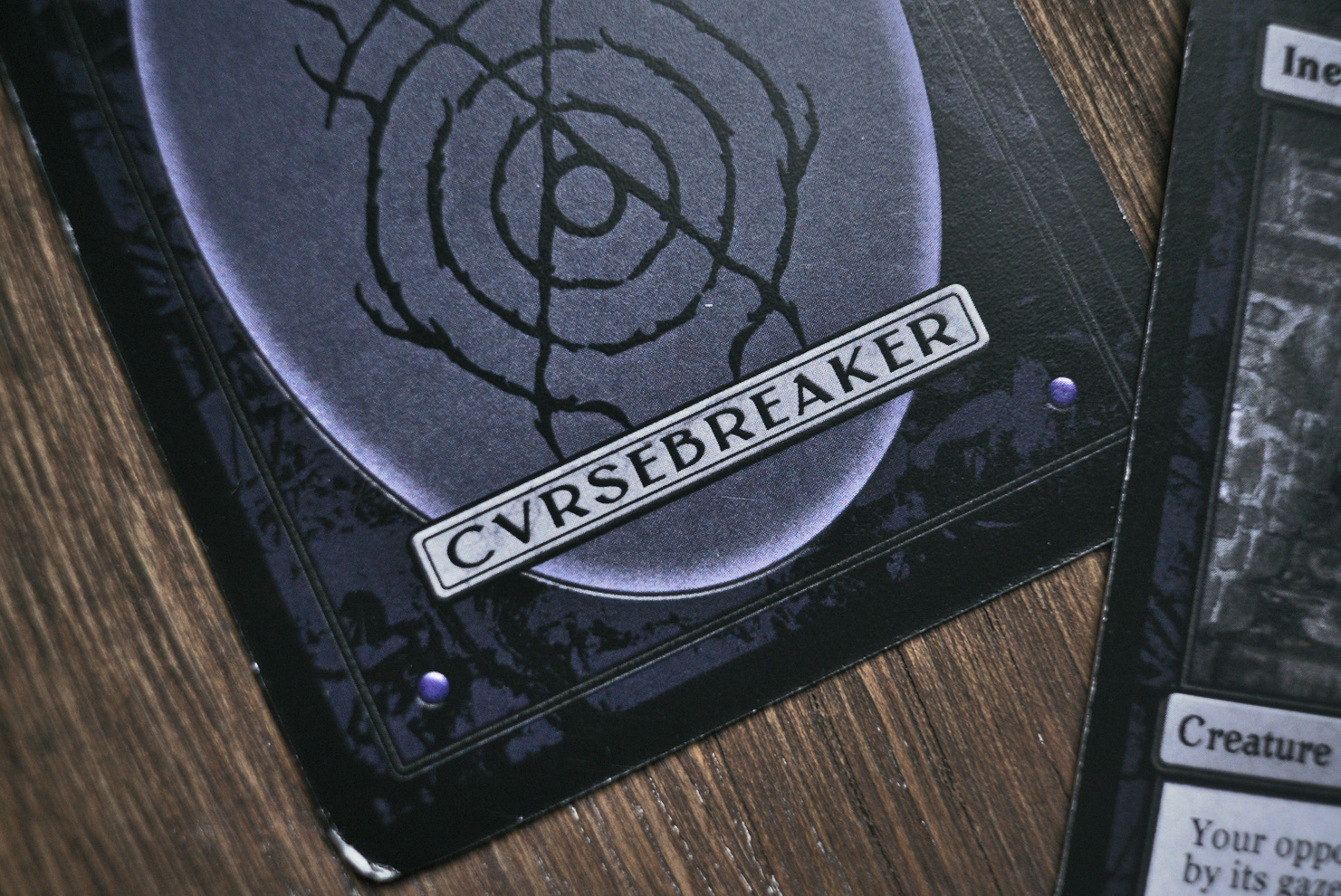 Detail of the sigl and cvrsebreaker text on the back of the card